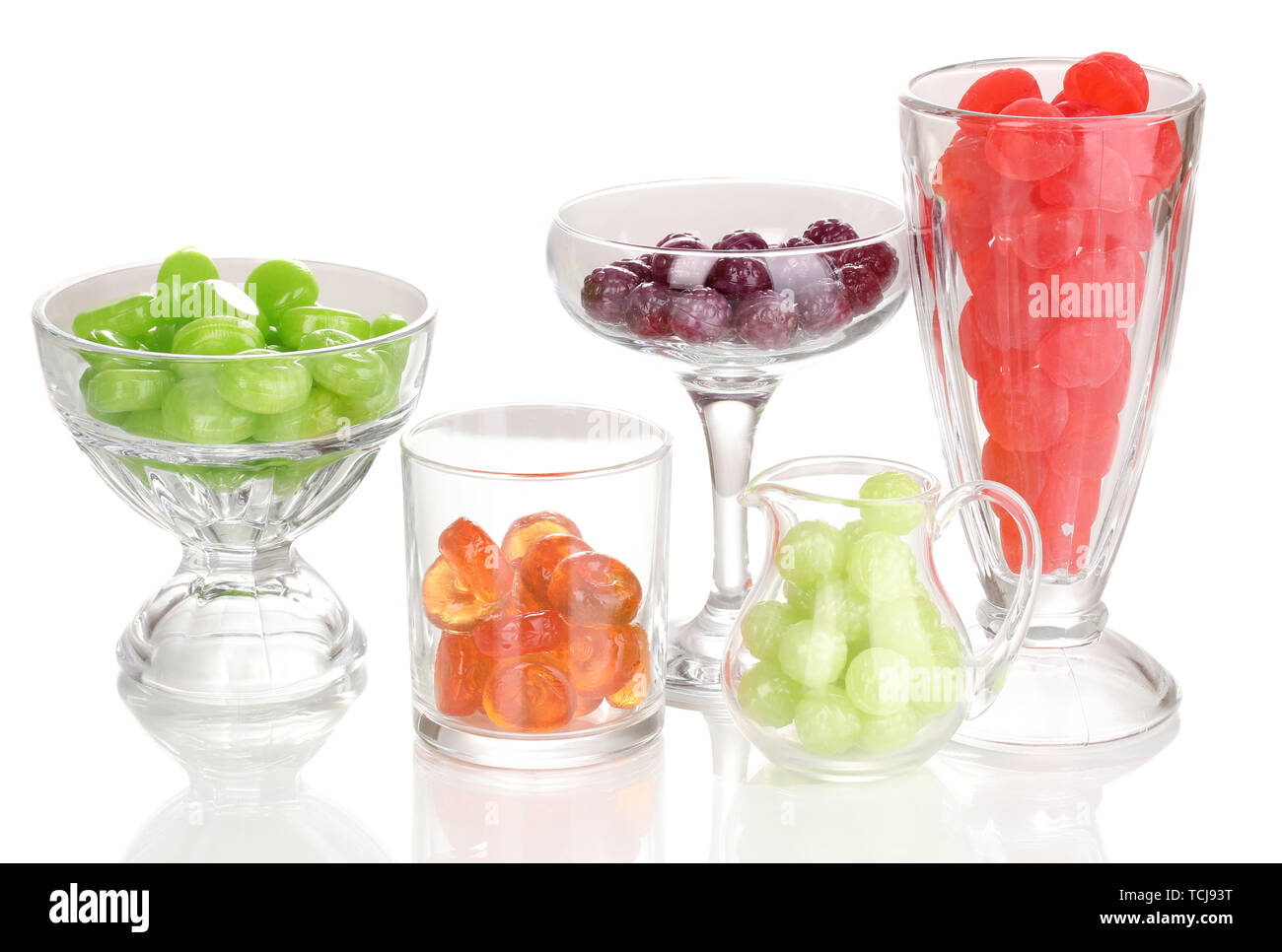 Color candies in glasses isolated on white Stock Photo - Alamy