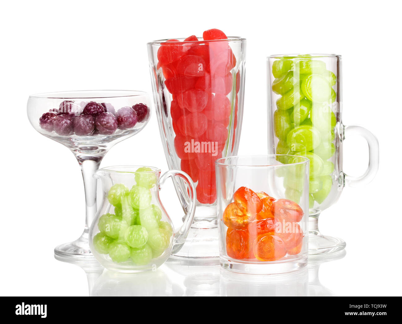Color candies in glasses isolated on white Stock Photo - Alamy