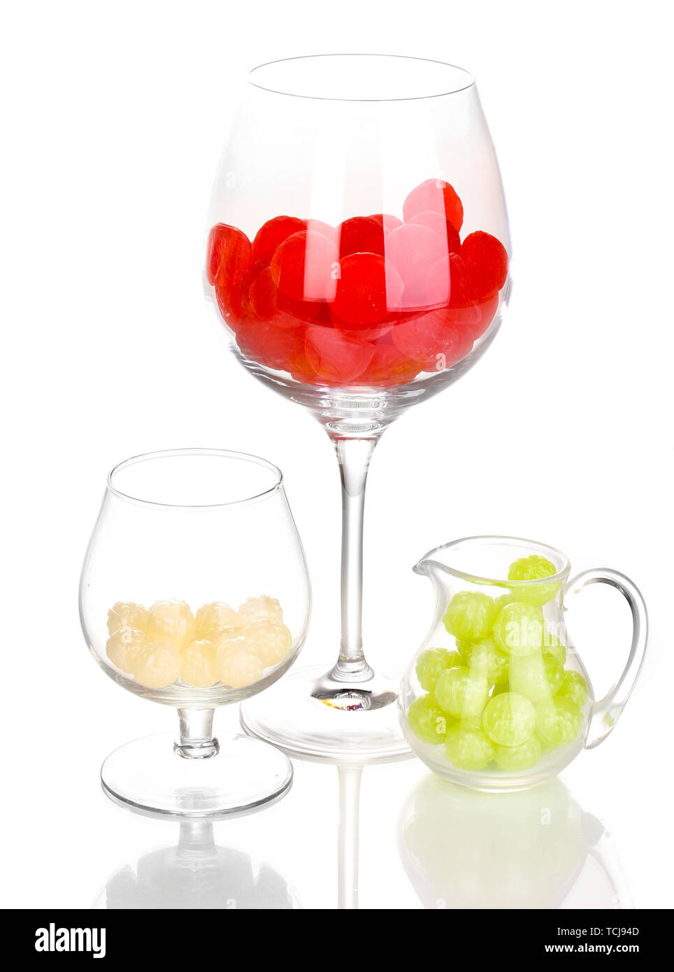 Color candies in glasses isolated on white Stock Photo - Alamy