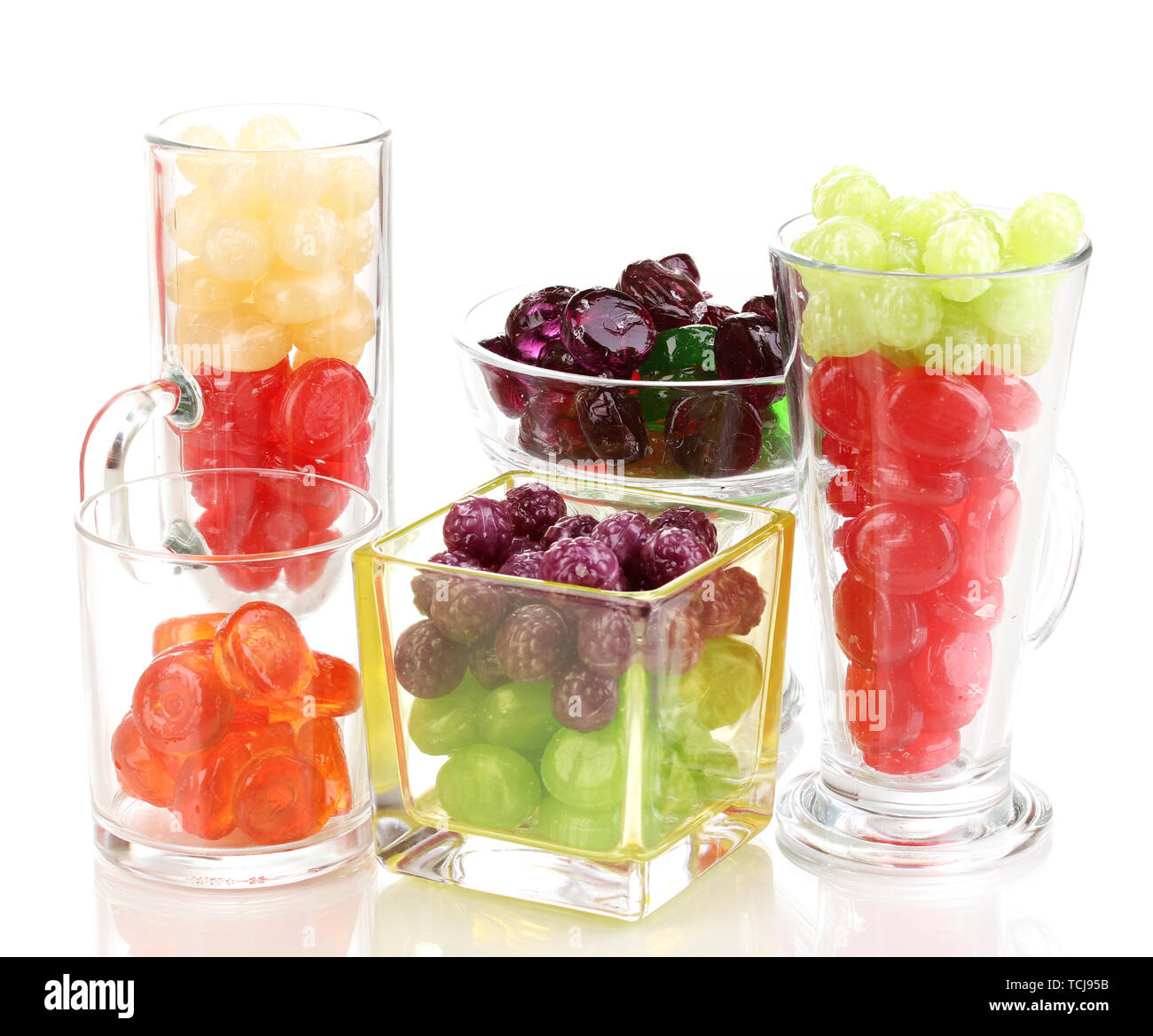 Color candies in glasses isolated on white Stock Photo - Alamy