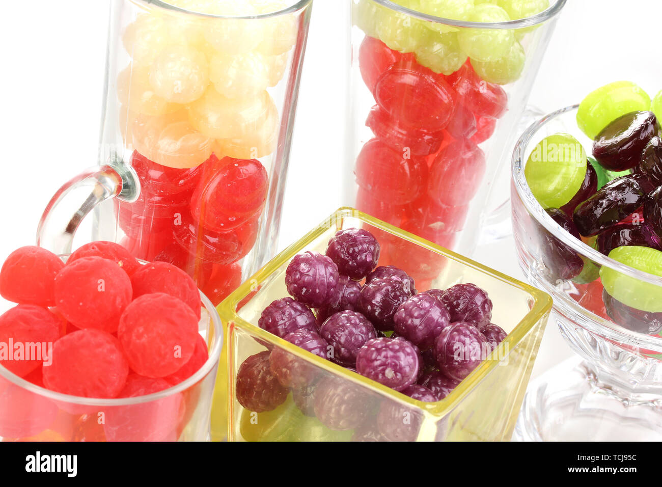 Color candies in glasses isolated on white Stock Photo - Alamy