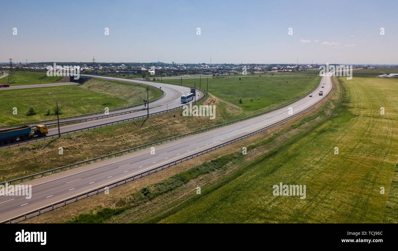Aerial view of modern highway road intersection on rural landscape ...