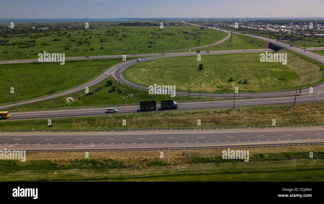 Aerial view of modern highway road intersection on rural landscape ...
