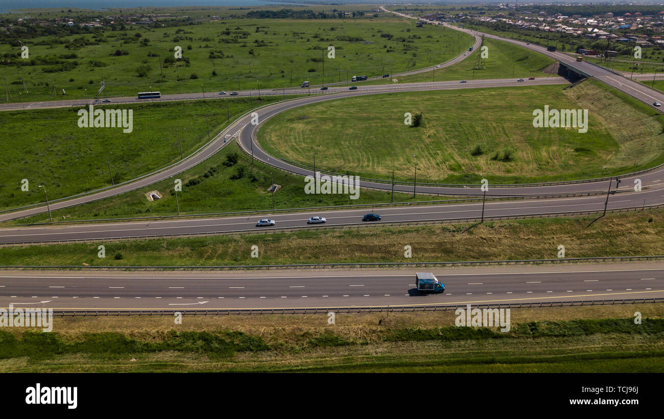 Aerial view of modern highway road intersection on rural landscape ...