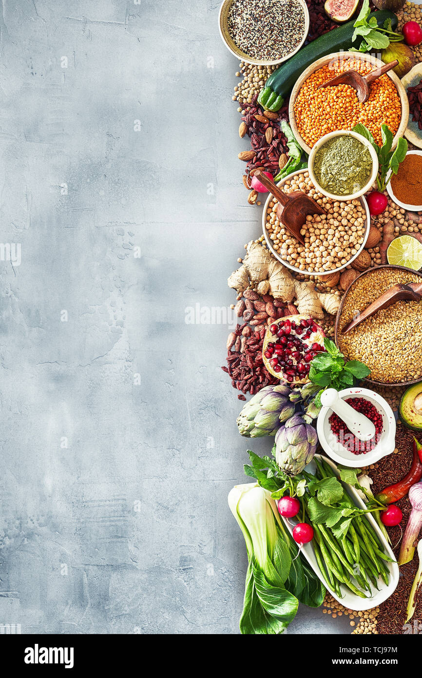 Food border with a large assortment of fresh fruit, spice, herbs and ...