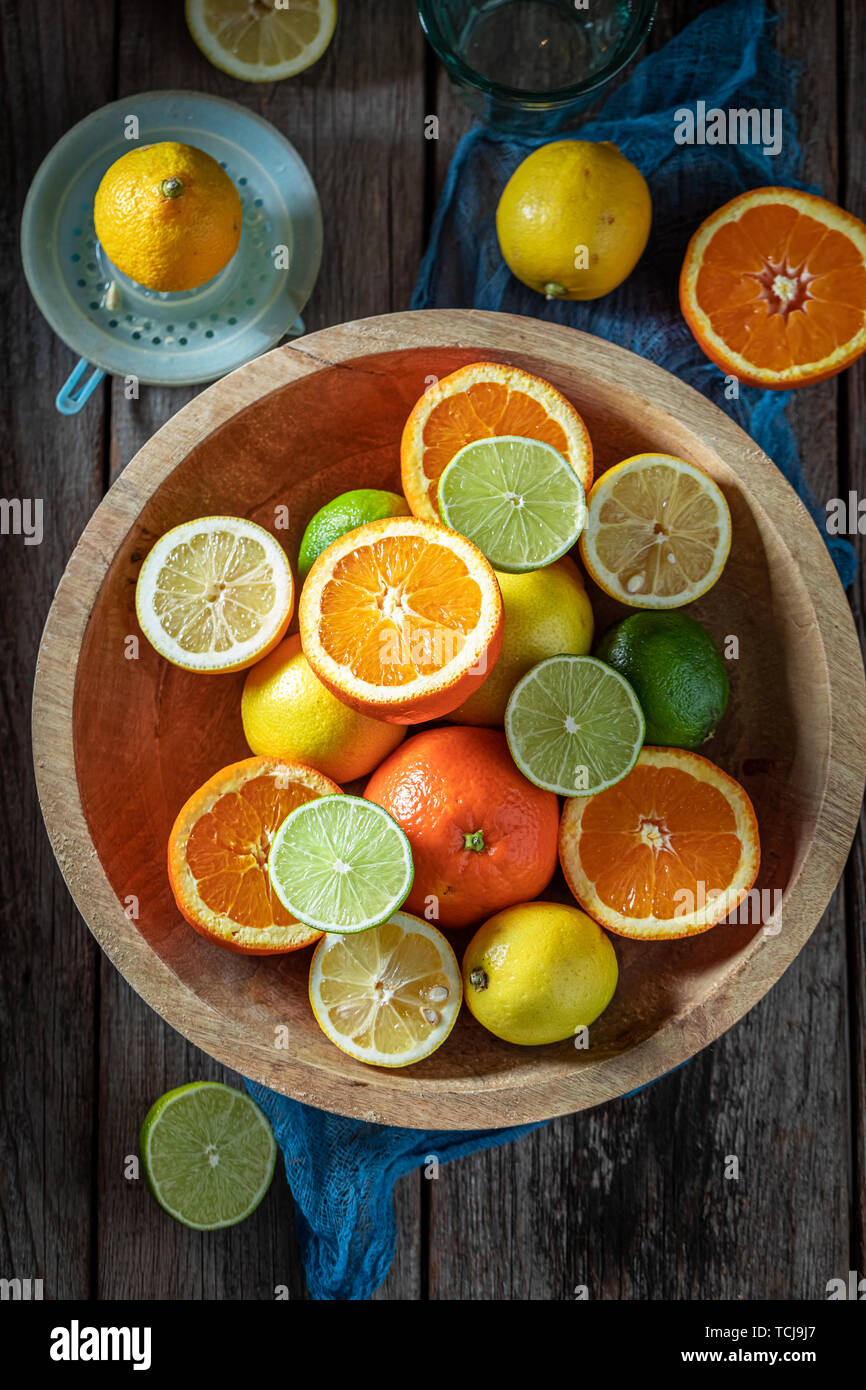 Tasty mix of citrus fruits on old wooden table Stock Photo - Alamy