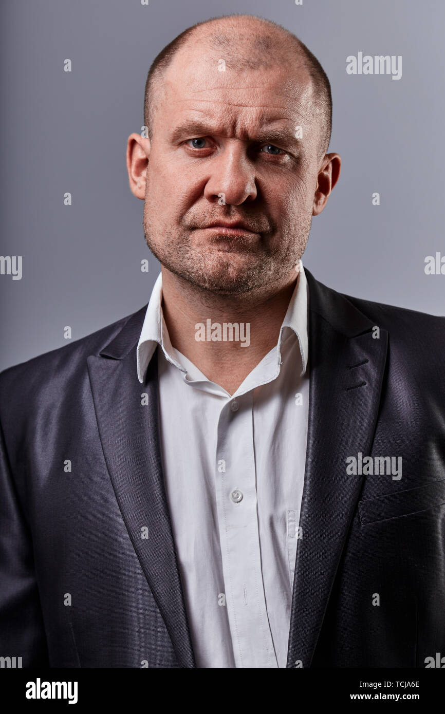 Serious angry emotion man in suit looking. Closeup portrait of actor on ...