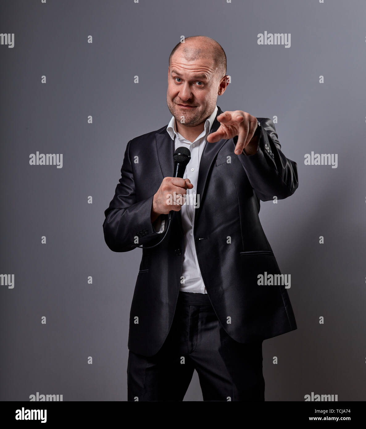 Fun emotional moving happy performer man presenting the show holding ...