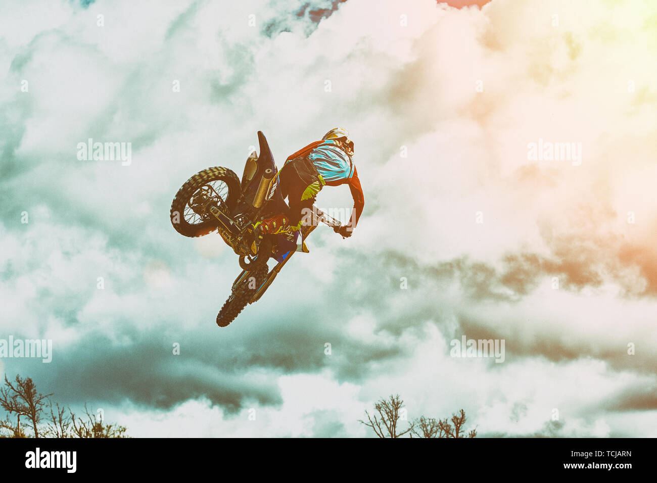 Extreme sports, motorcycle jumping. Motorcyclist makes an extreme jump ...