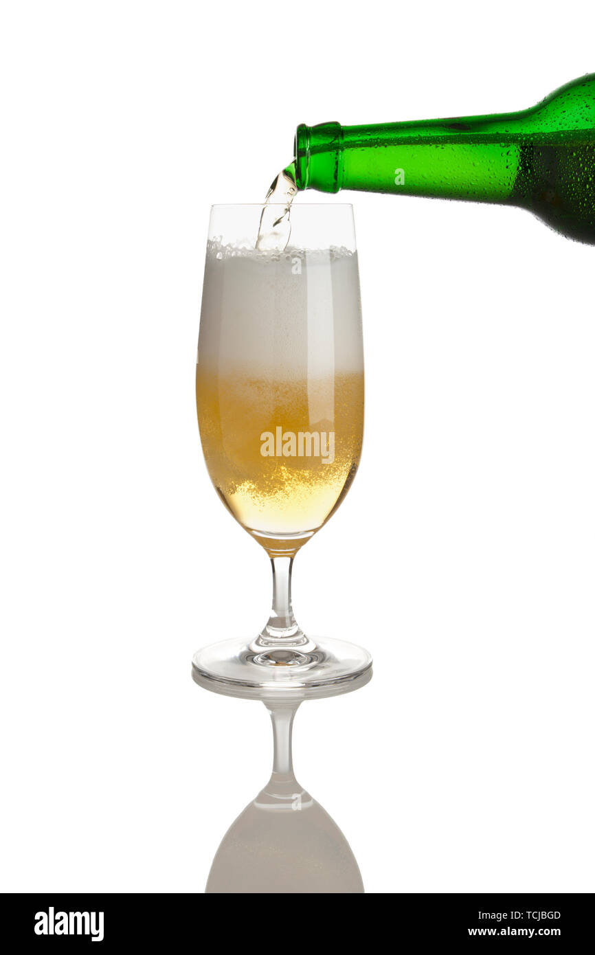 beer flowing from bottle into glass Stock Photo - Alamy