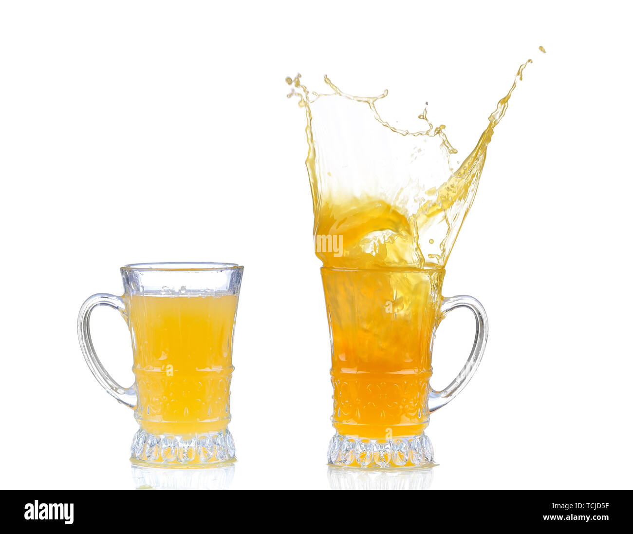 orange juice splash in glass isolated on white Stock Photo - Alamy