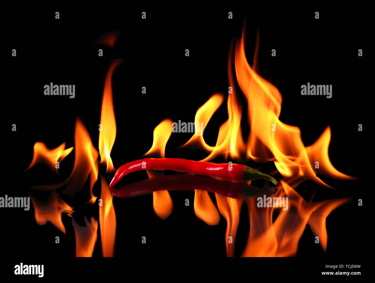 Hot pepper with flame on black background Stock Photo - Alamy