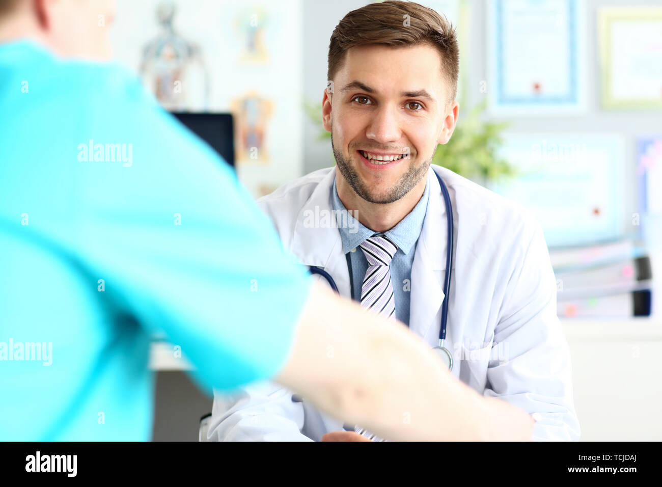 Thoughtful doctor smiling in clinic hi-res stock photography and images ...
