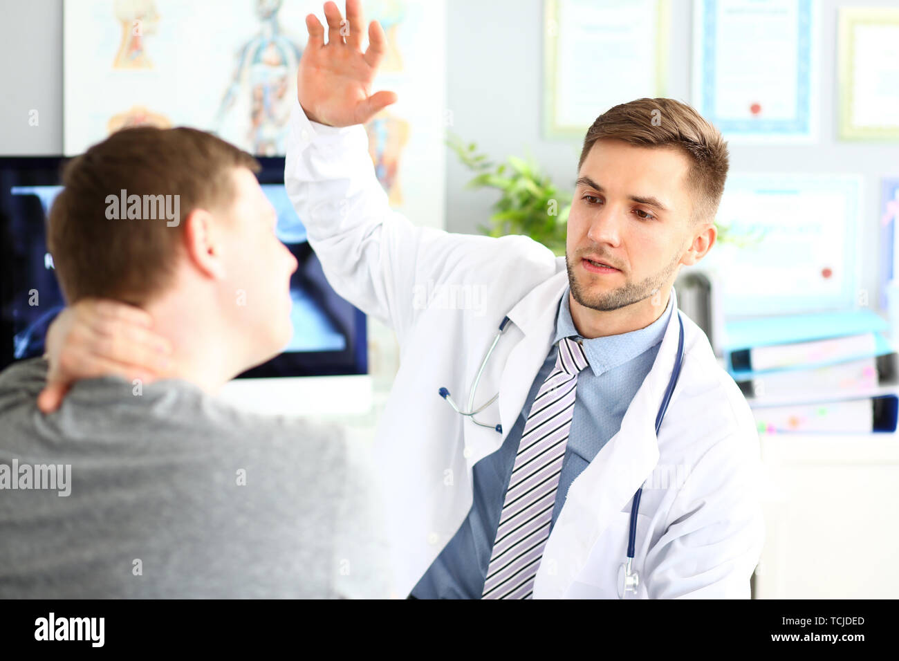 Doctor showing exercises for health Stock Photo - Alamy