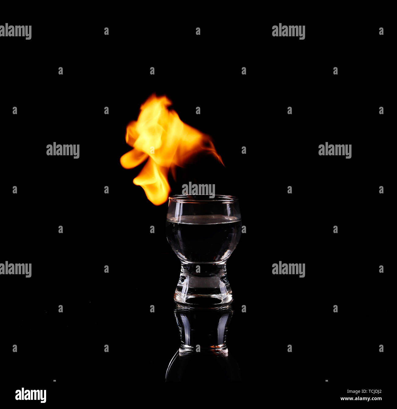 Glass of tequila and flames Stock Photo - Alamy