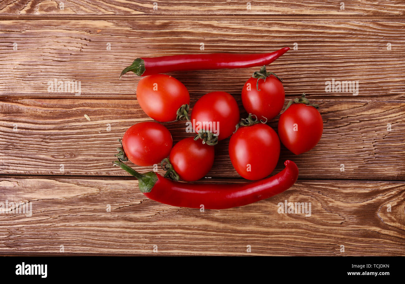 Red hot cherry and chili peppers over white wooden background Stock ...