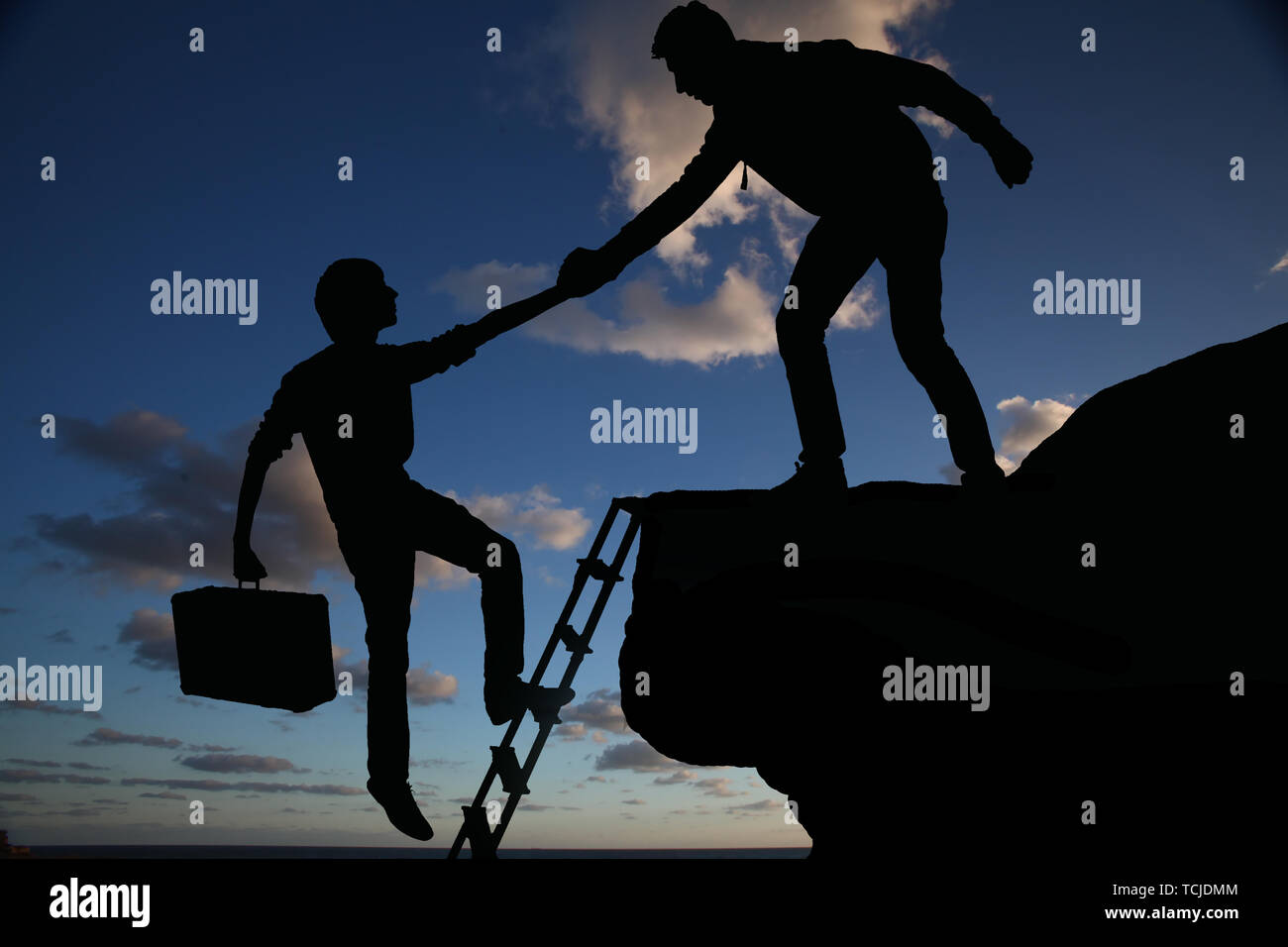 Teamwork of two men helping each other on top of mountain a career ...