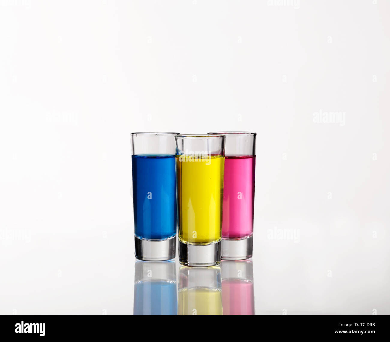 Shots - Three colourful shot drinks on a white background with ...
