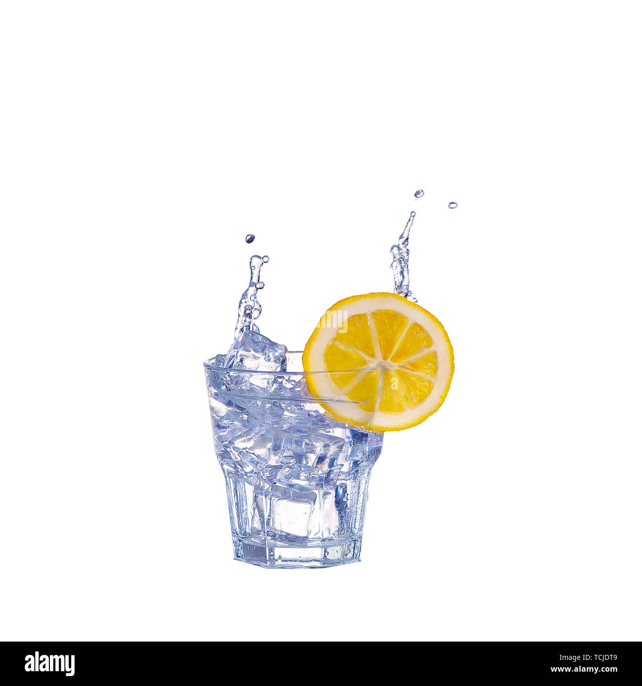 Glass of water, ice and slice of fresh lemon on a white background ...