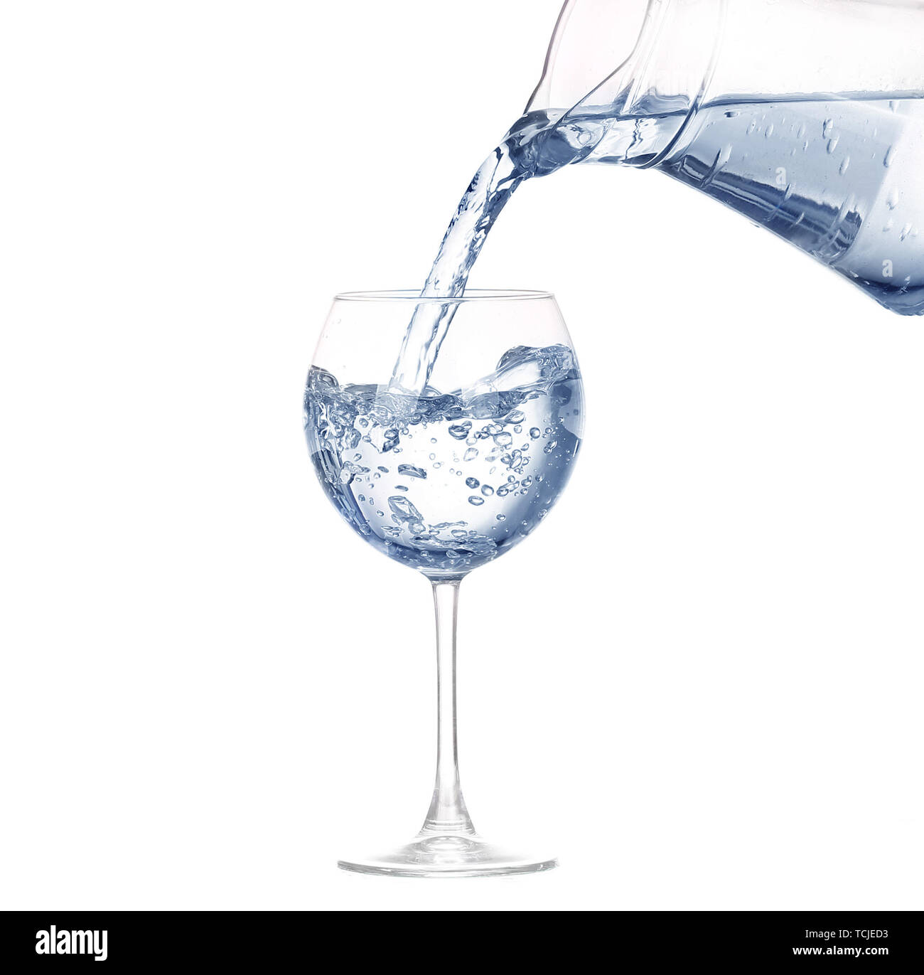 Pouring water from glass pitcher on white background Stock Photo - Alamy