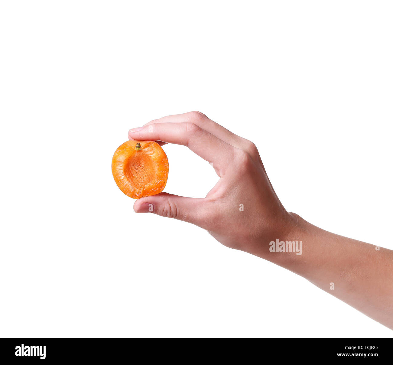 ripe apricots in a hand on a white background Stock Photo - Alamy
