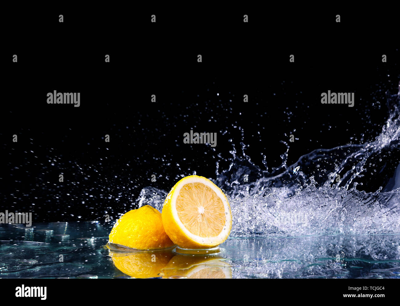 Sliced lemon in the water on black background. Fresh lemons with water ...