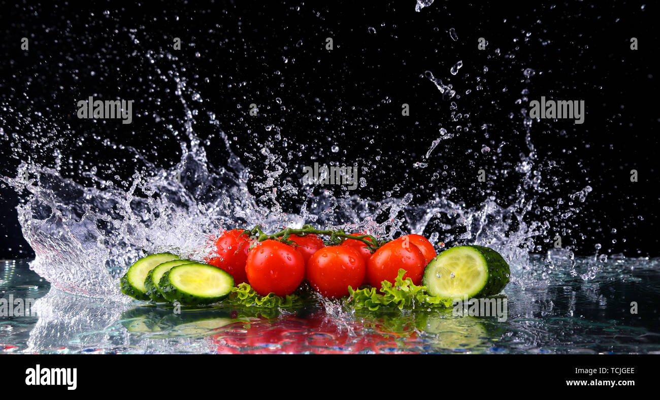 Studio shot with freeze motion of cherry tomatoes and slices of ...