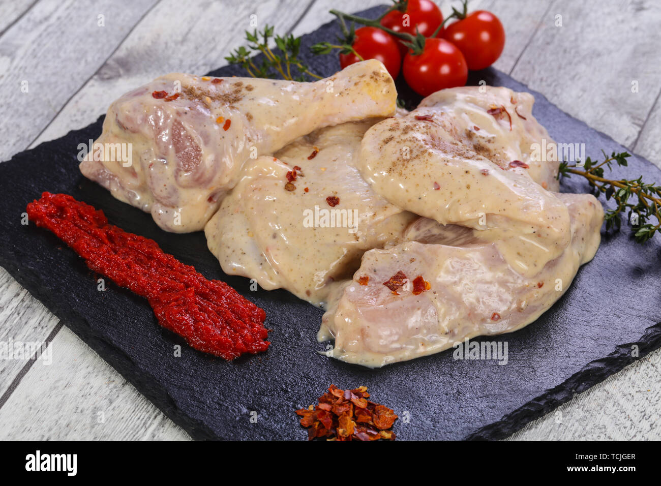 Marinated chicken parts ready for roast Stock Photo - Alamy