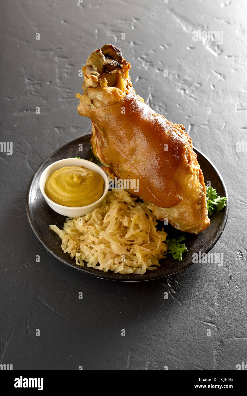Roasted pork knuckle (eisbein) with braised cabbage (sauerkraut) and ...