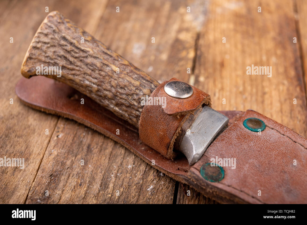 Old little dirty hunting knife on a wooden table. Hunting accessories ...