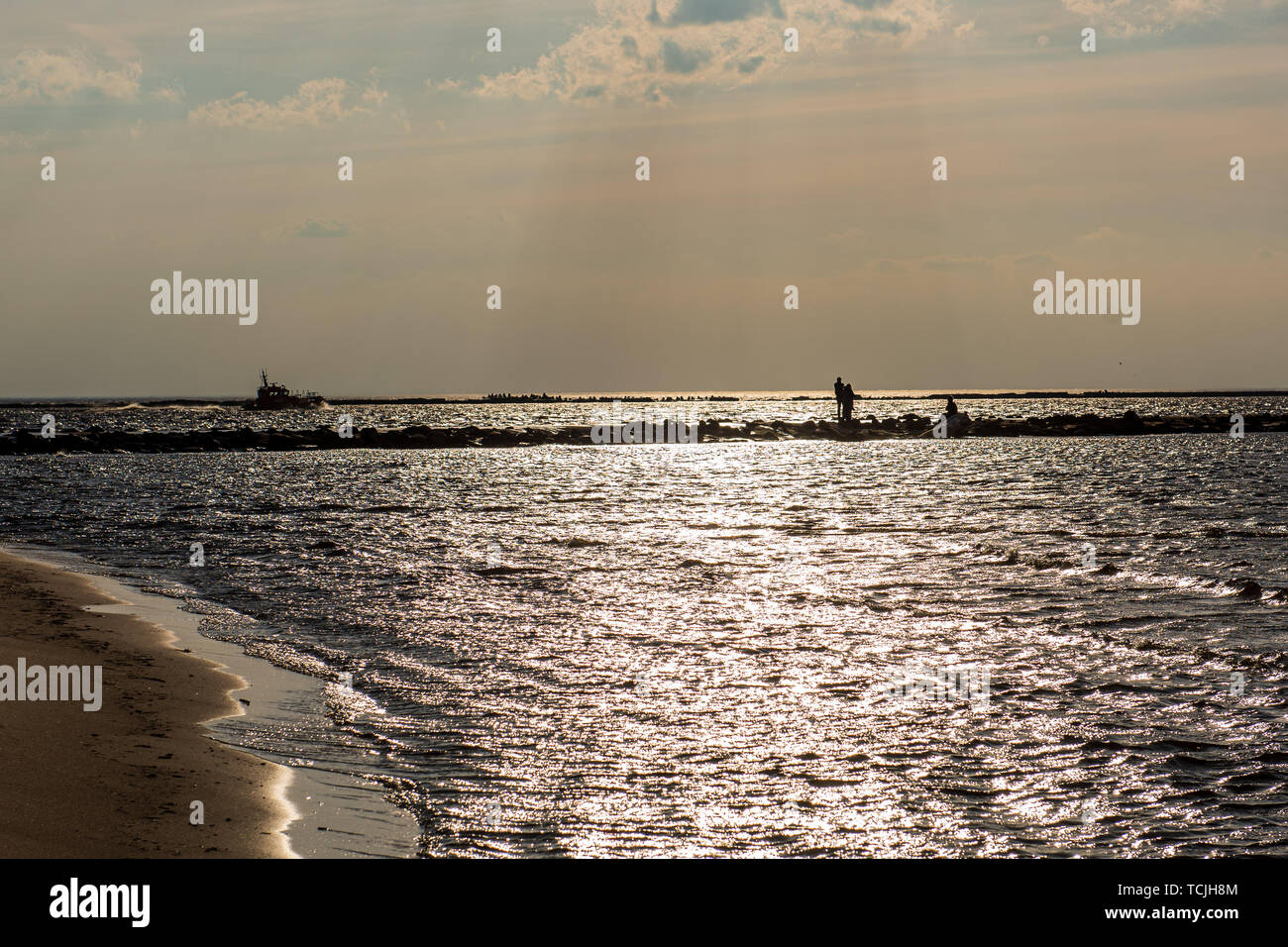windy sea beach with white sand and blue water and dramatic clouds in ...