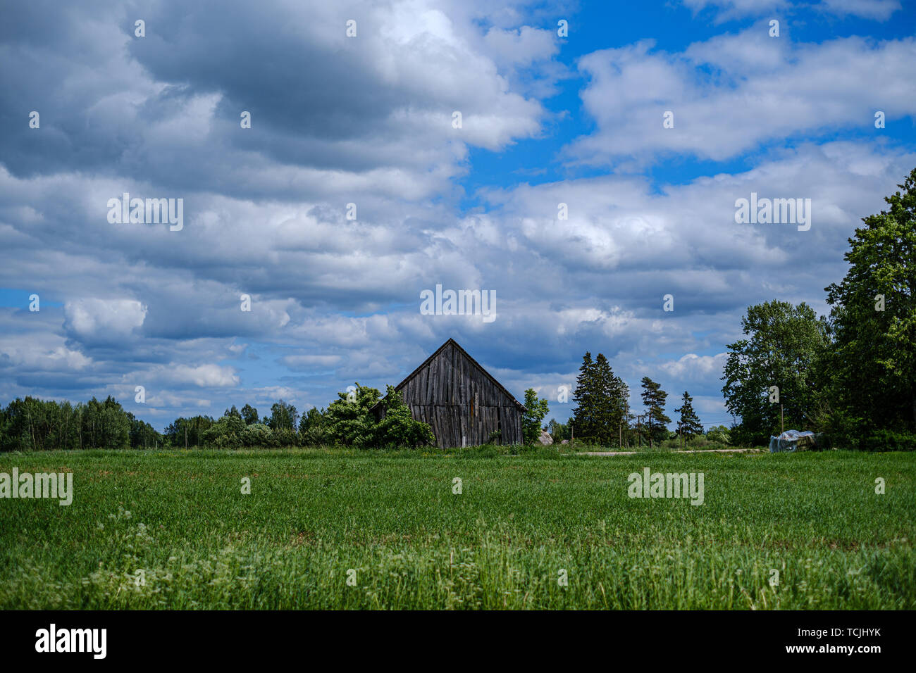 countryside landscape under blue sky and dramatic white clouds in ...