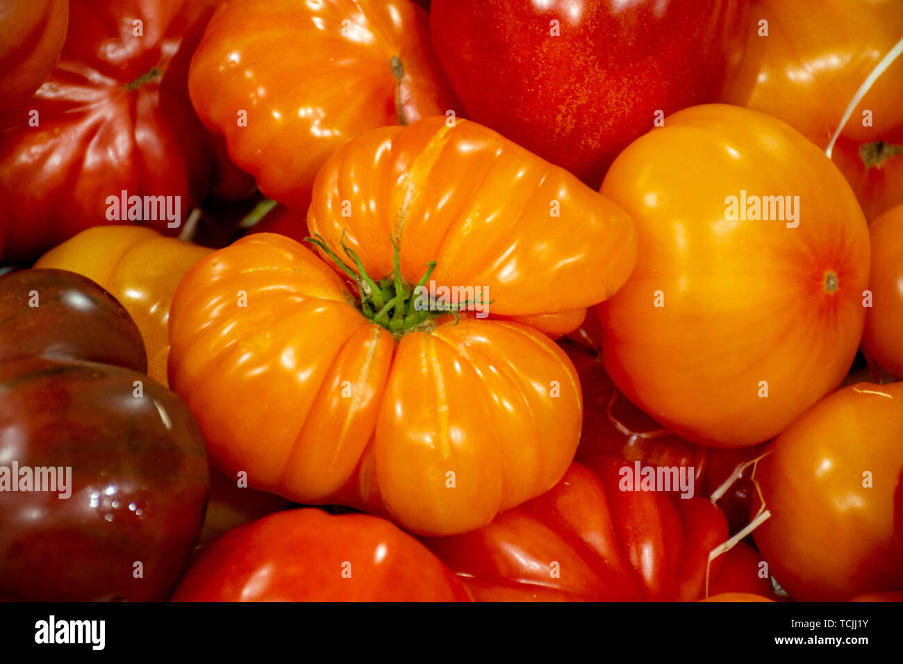 Big ripe french tomatoes, food background close up Stock Photo - Alamy