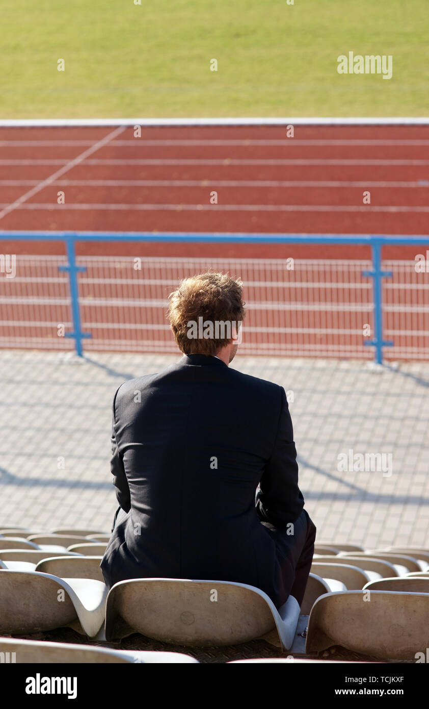 Spectator or Trainer sitting in Stadium in Front of Running Track Stock ...