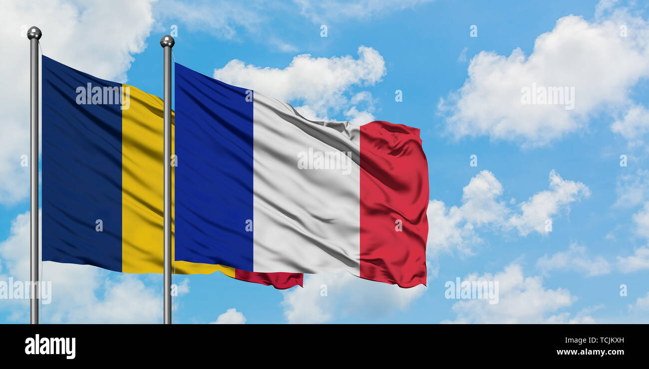 Chad and France flag waving in the wind against white cloudy blue sky ...