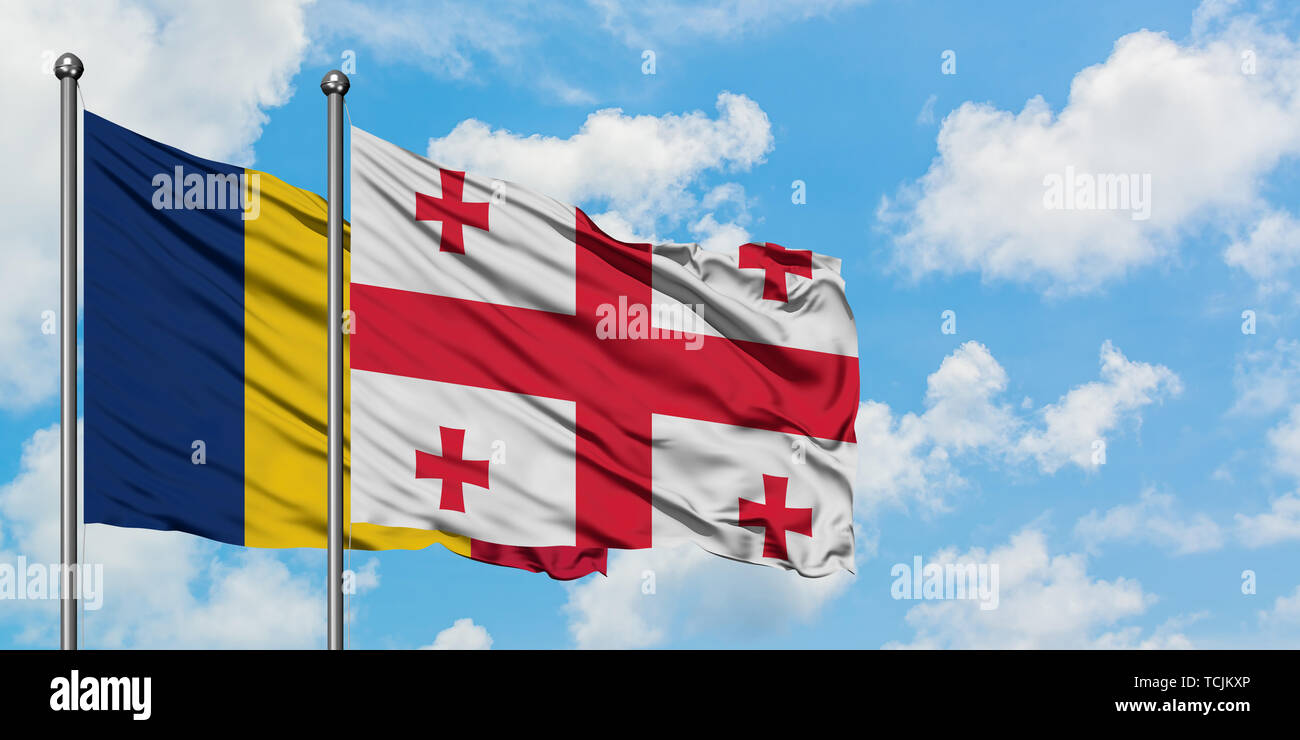Chad and Georgia flag waving in the wind against white cloudy blue sky ...