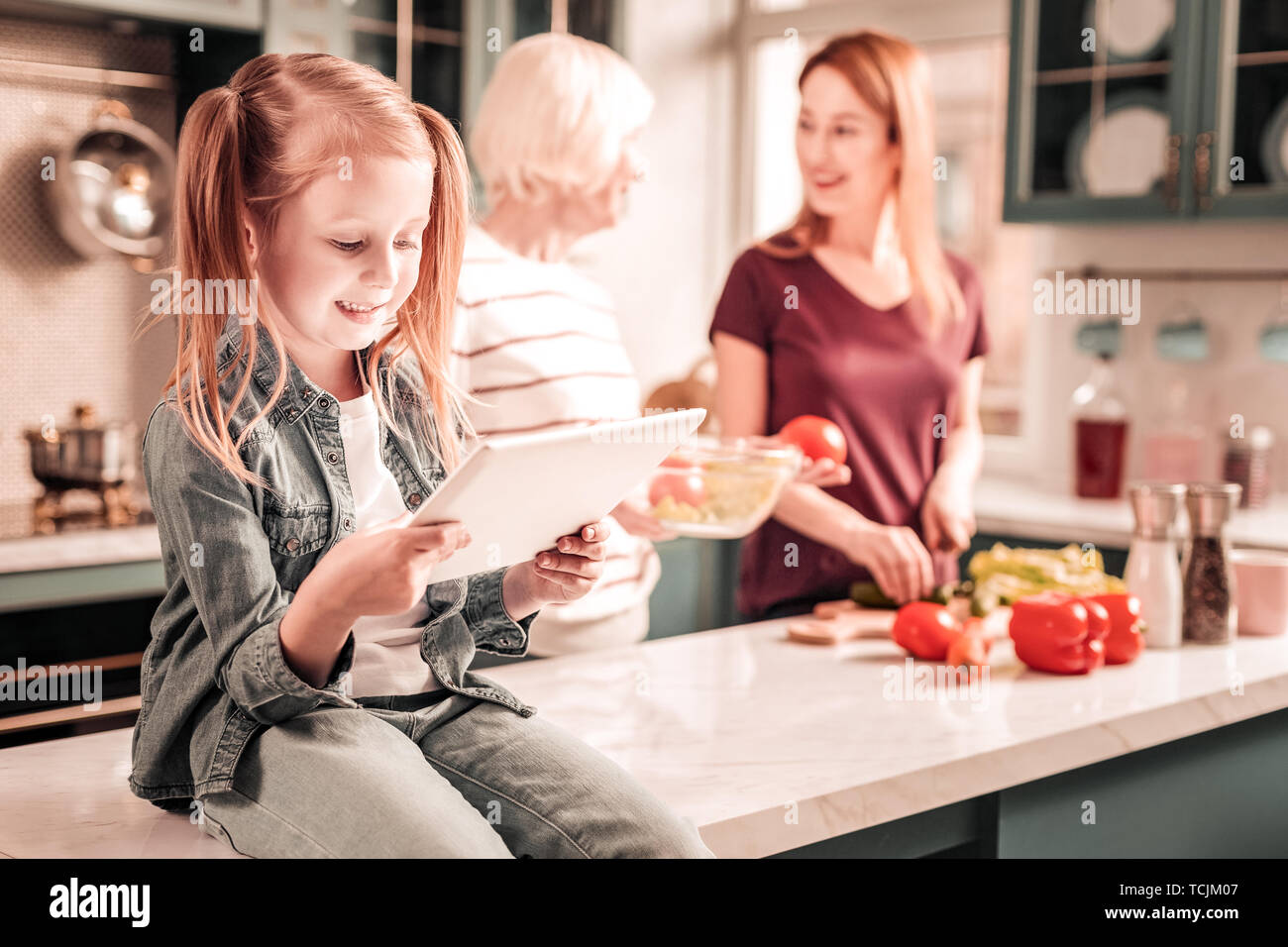 Funny girl staring at her modern tablet Stock Photo - Alamy