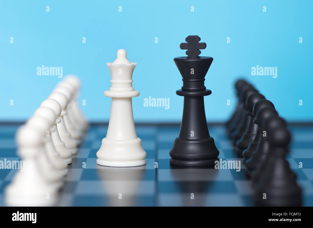 Chess game and blue background. Conceptual scene Stock Photo - Alamy