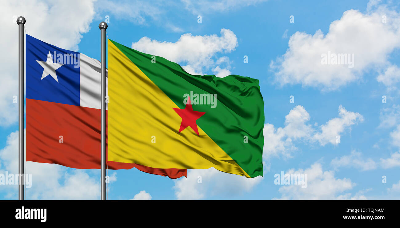 Chile and French Guiana flag waving in the wind against white cloudy ...