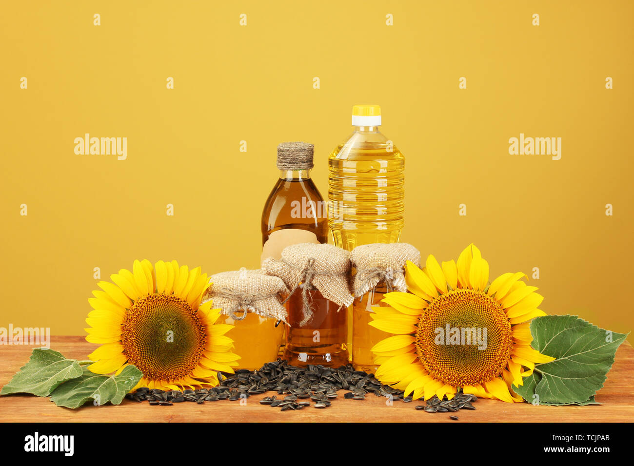 sunflower oil and sunflower on yellow background Stock Photo - Alamy