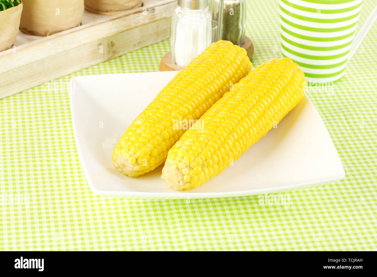boiled corn and flowers on a white background Stock Photo - Alamy