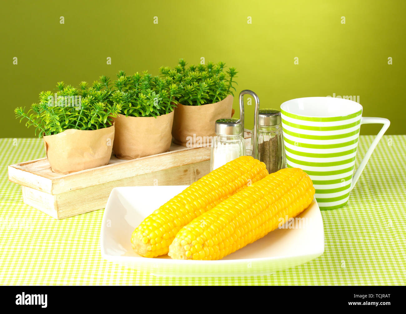 boiled corn and flowers on a green background Stock Photo - Alamy
