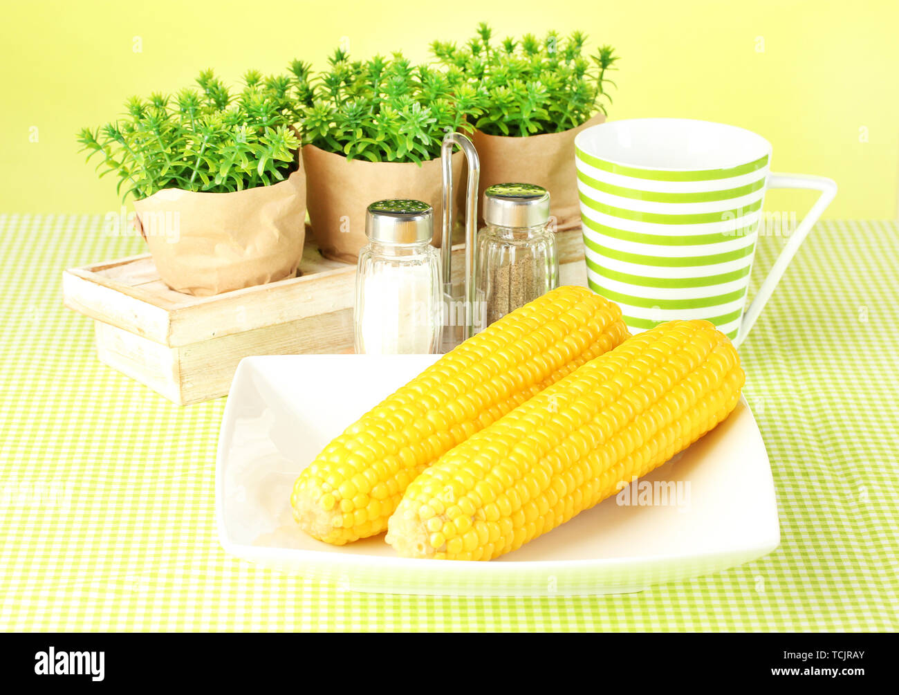 boiled corn and flowers on a green background Stock Photo - Alamy