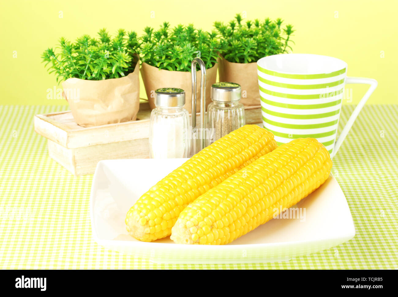 boiled corn and flowers on a green background Stock Photo - Alamy