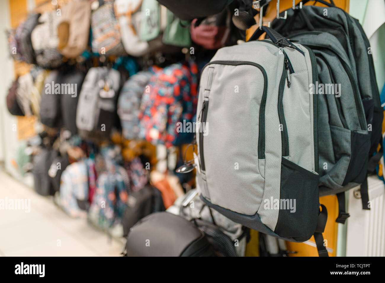 Showcase with backpacks in sports shop, nobody Stock Photo - Alamy
