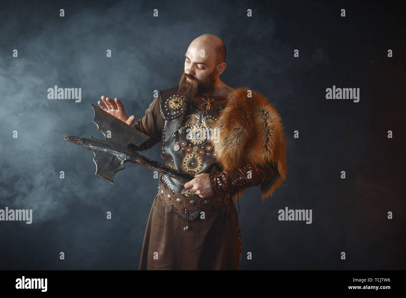 Bearded viking touches the axe blade Stock Photo - Alamy