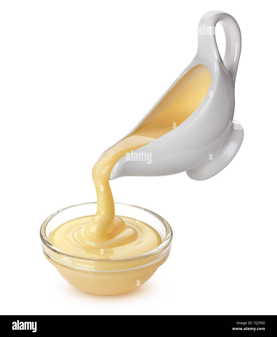 Pouring condensed milk isolated on white background Stock Photo - Alamy
