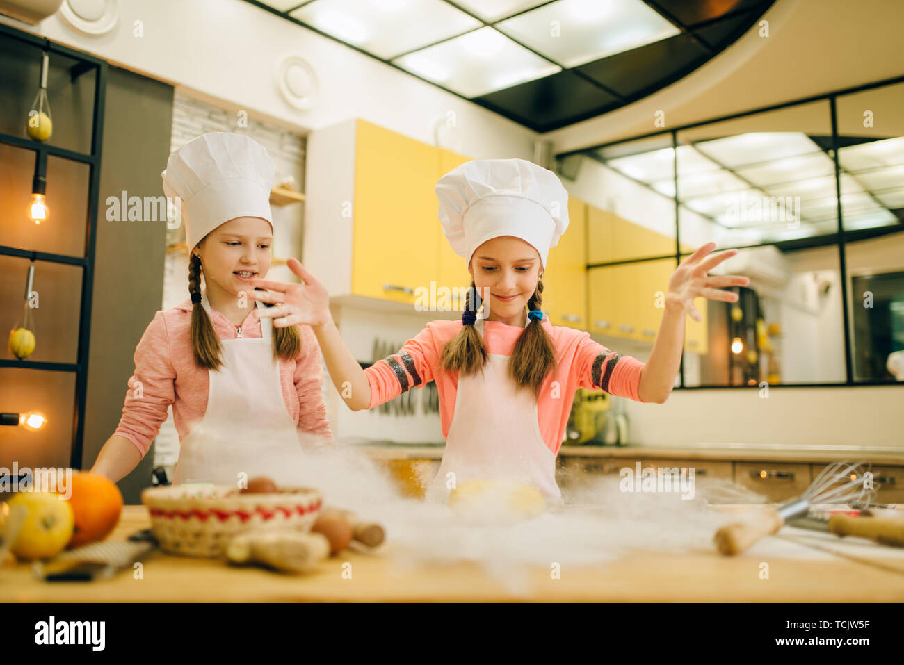 Little girls chefs prepared dough, funny bakers Stock Photo - Alamy