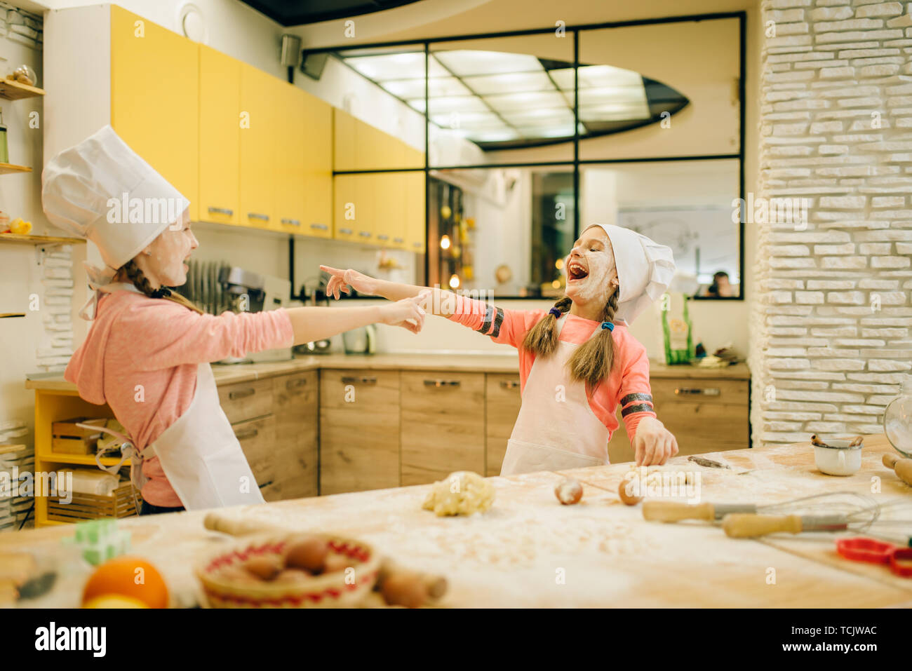 Two little girls chefs are laughing at each other Stock Photo - Alamy