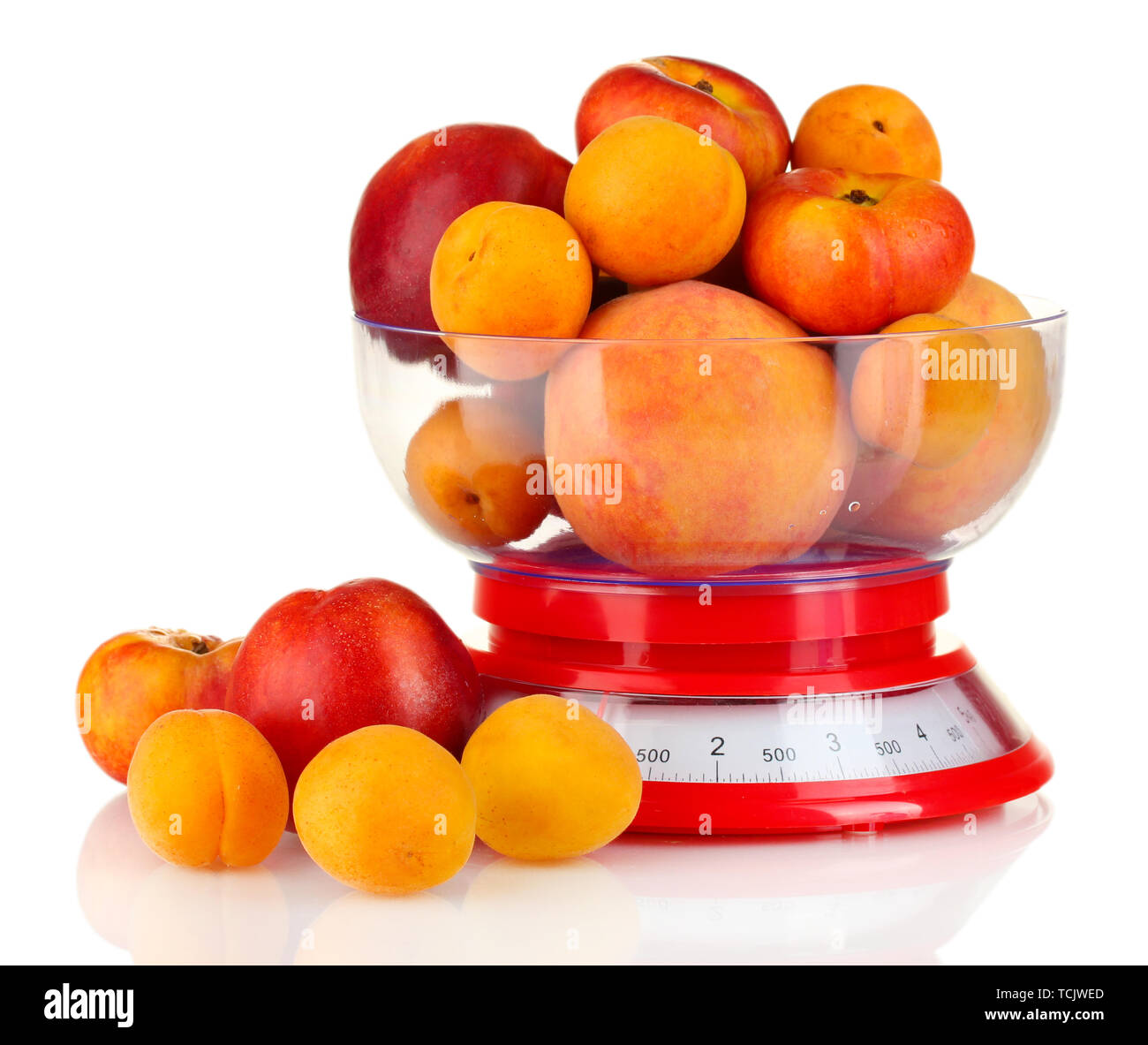 Ripe fruit in kitchen scales isolated on white Stock Photo - Alamy